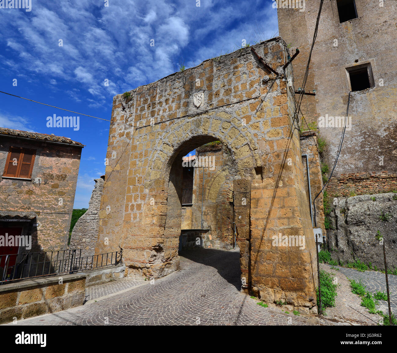 Medieval gate with old noble emblem of the ruined walls of of Faleria ...