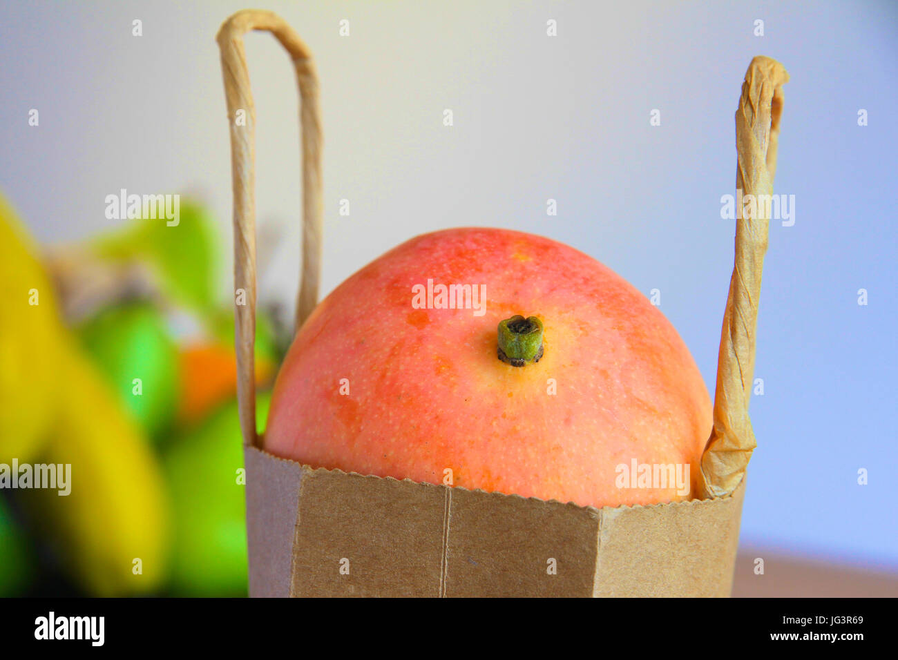 A mango in a brown paper bag Stock Photo - Alamy