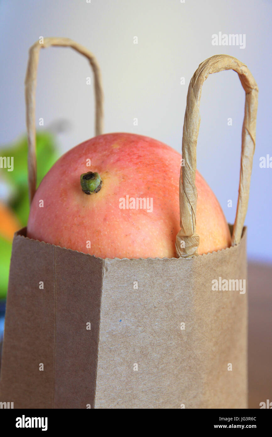A mango in a brown paper bag Stock Photo - Alamy