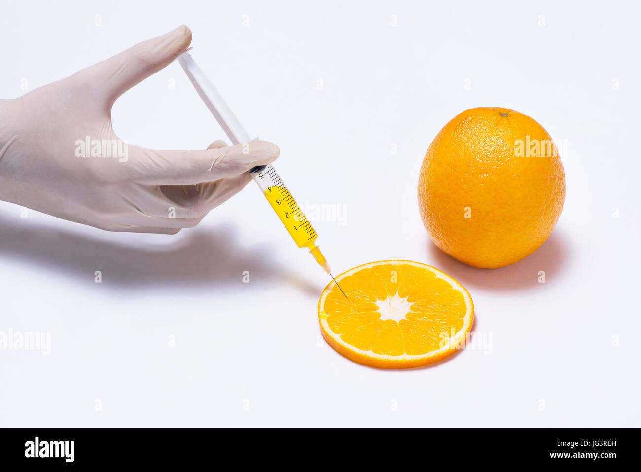 Science experiment with orange and syringe isolated on white Stock ...