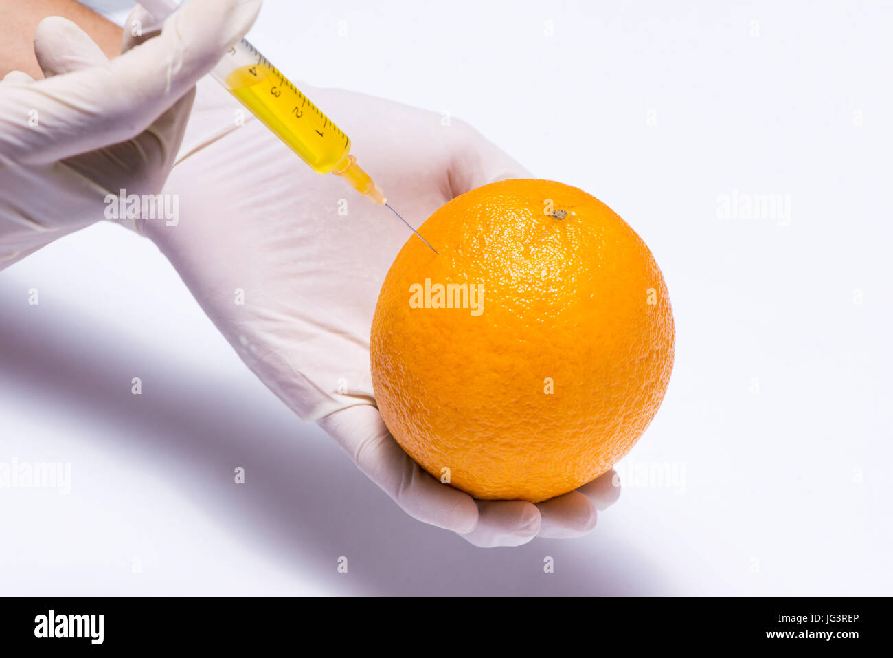 Science experiment with orange and syringe isolated on white Stock ...