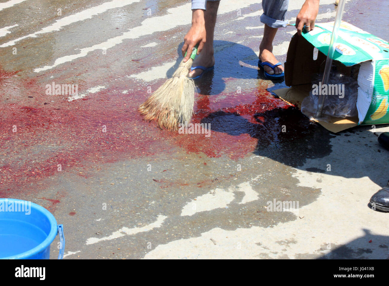 Anantnag, India. 02nd July, 2017. A policeman washing blood stains from ...
