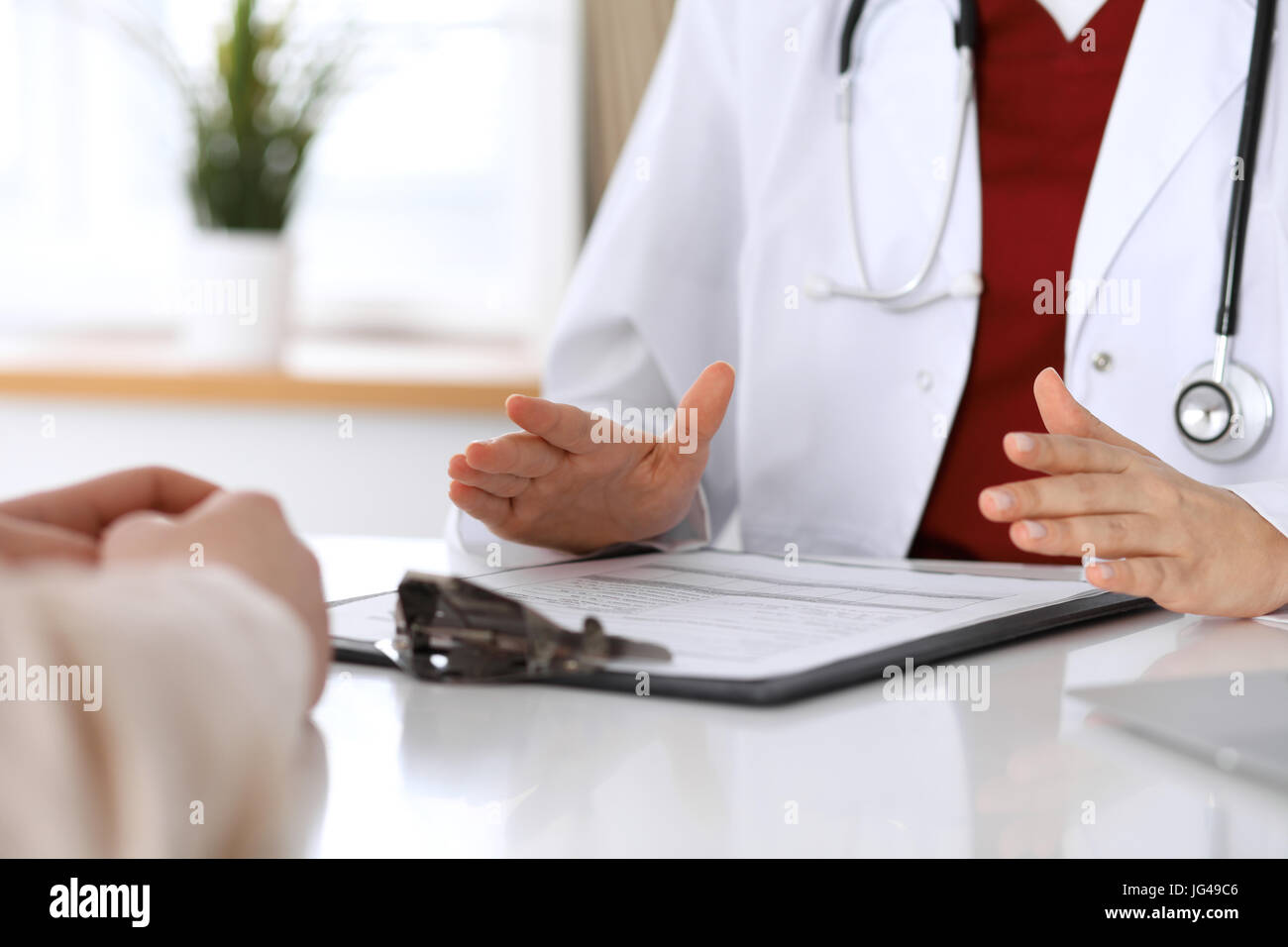 Hand of doctor reassuring her female patient Stock Photo - Alamy