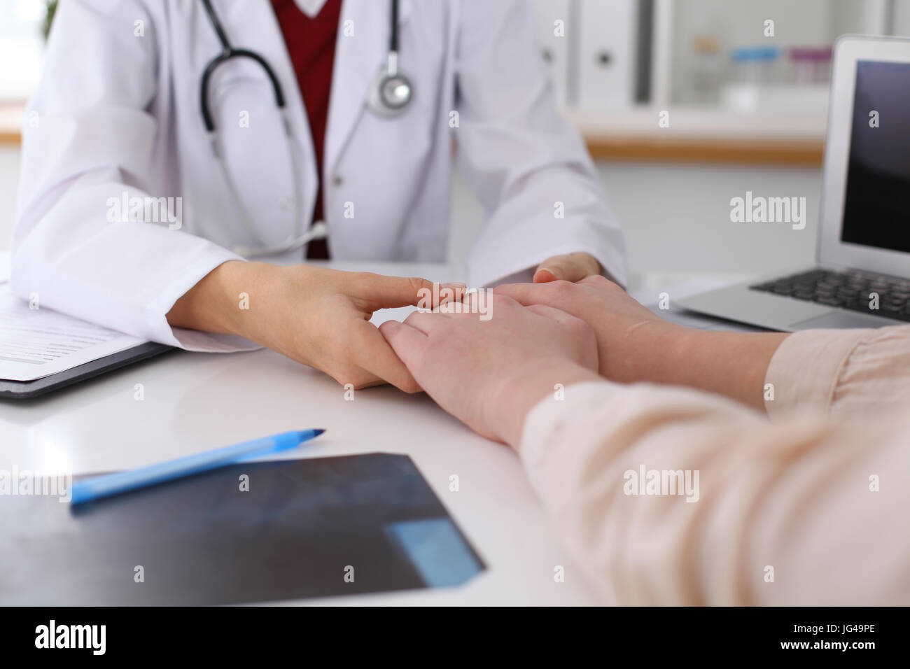 Hand of doctor reassuring her female patient Stock Photo - Alamy