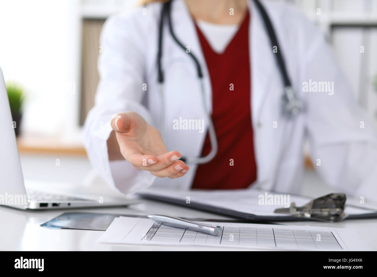 Female medicine doctor offering helping hand in office closeup ...
