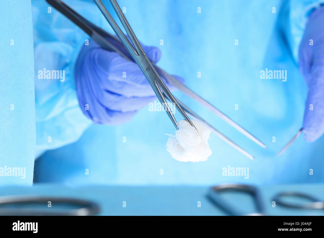 Close-up of of surgeons hands at work in operating theater toned in ...