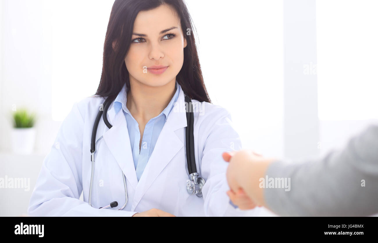 Doctor and patient shaking hands to each other. Healthcare, medicine ...