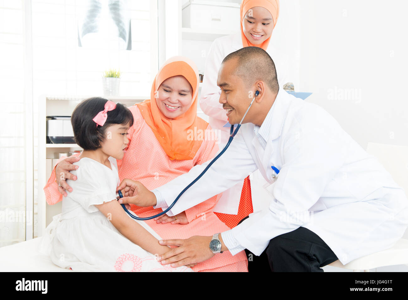 Illness Southeast Asian child patient consulting medical doctor. Muslim ...