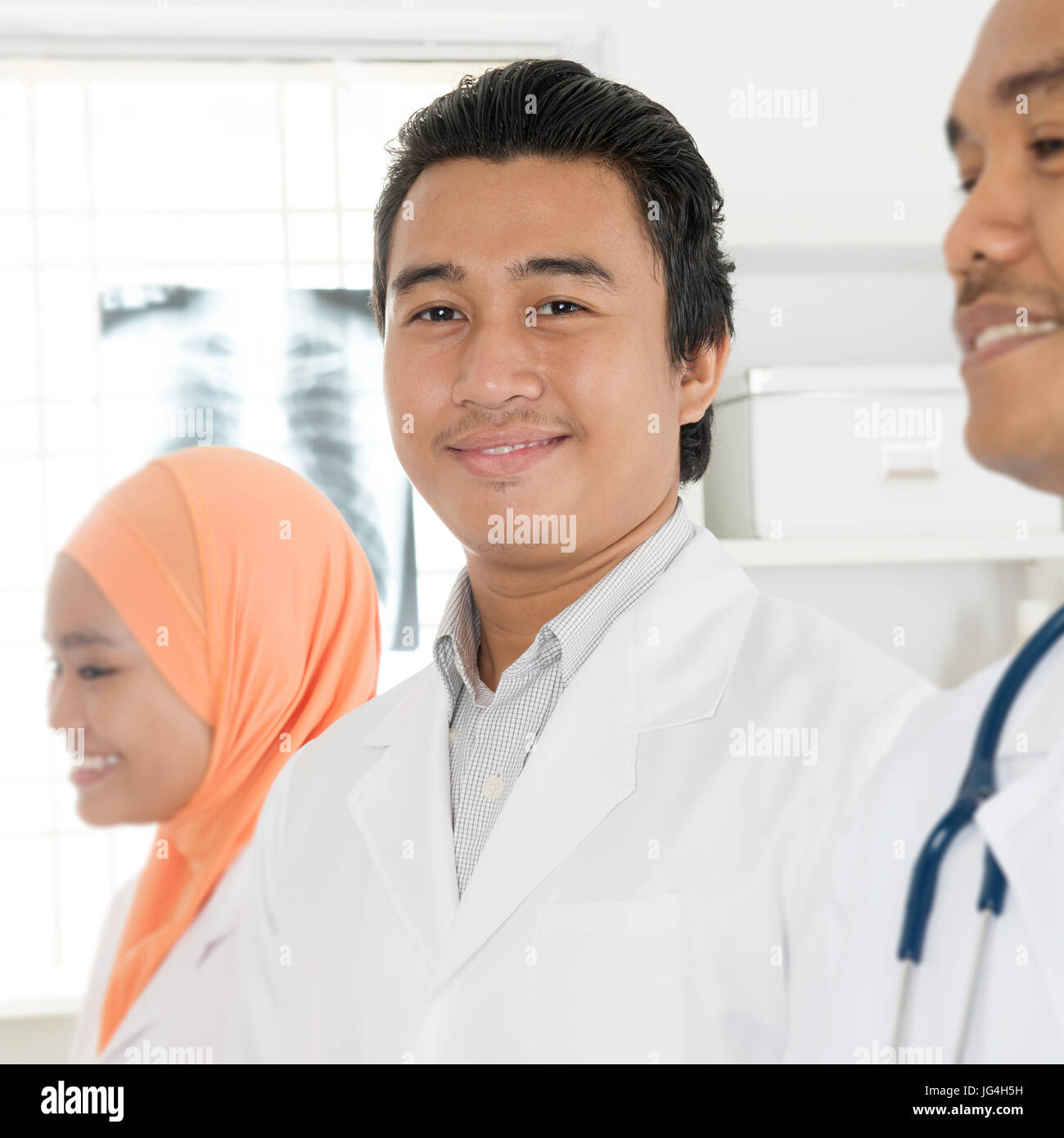 Portrait of medical team standing in hospital, Southeast Asian Muslim ...