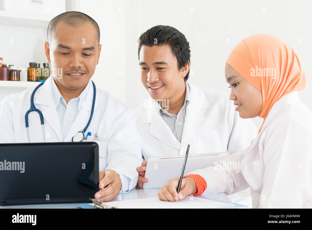 Group of doctors looking in computer hi-res stock photography and ...