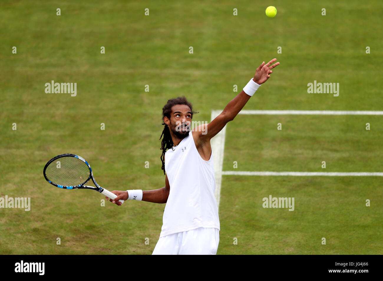 Dustin Brown in action against Joao Sousa on day one of the Wimbledon ...