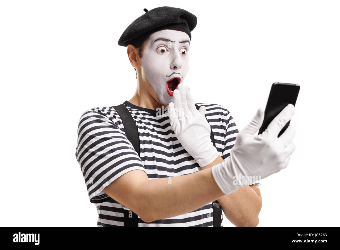 Surprised mime looking at a phone isolated on white background Stock ...