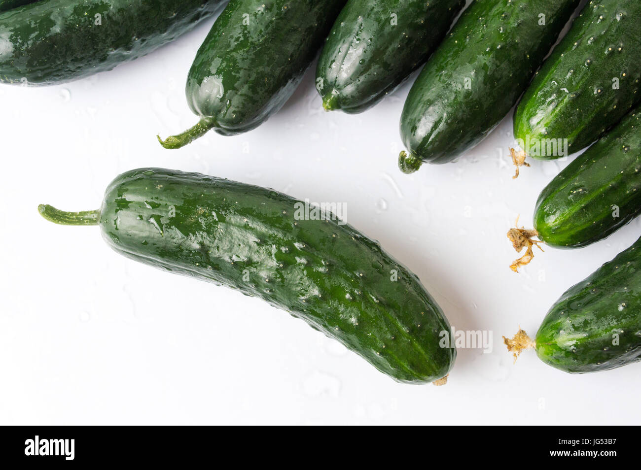 Freshly washed cucumbers on white wooden table Stock Photo - Alamy