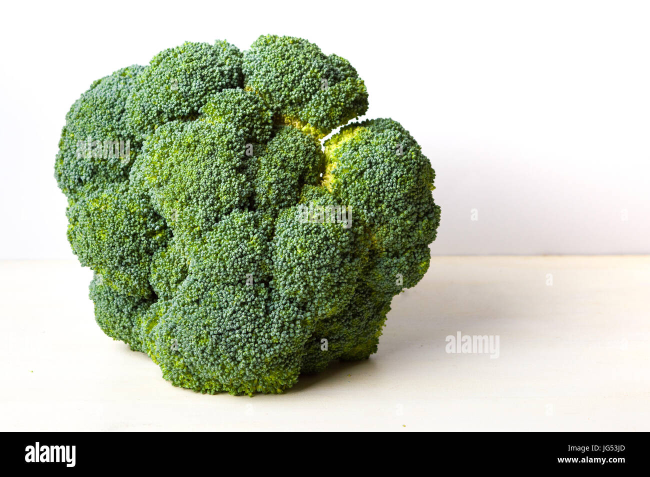 Big broccoli on a white wooden table Stock Photo - Alamy