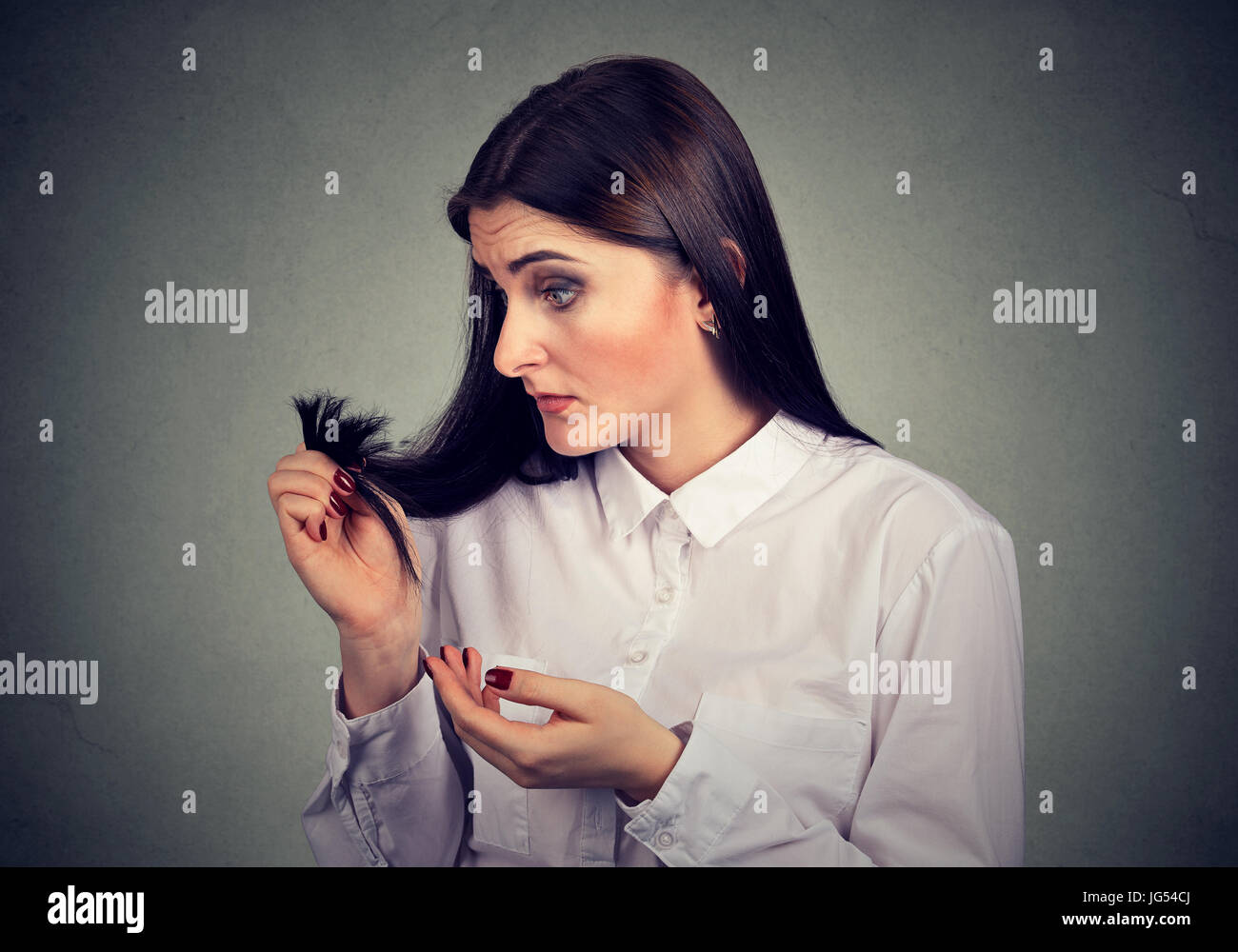 Unhappy frustrated woman surprised she is losing hair, noticed split ...
