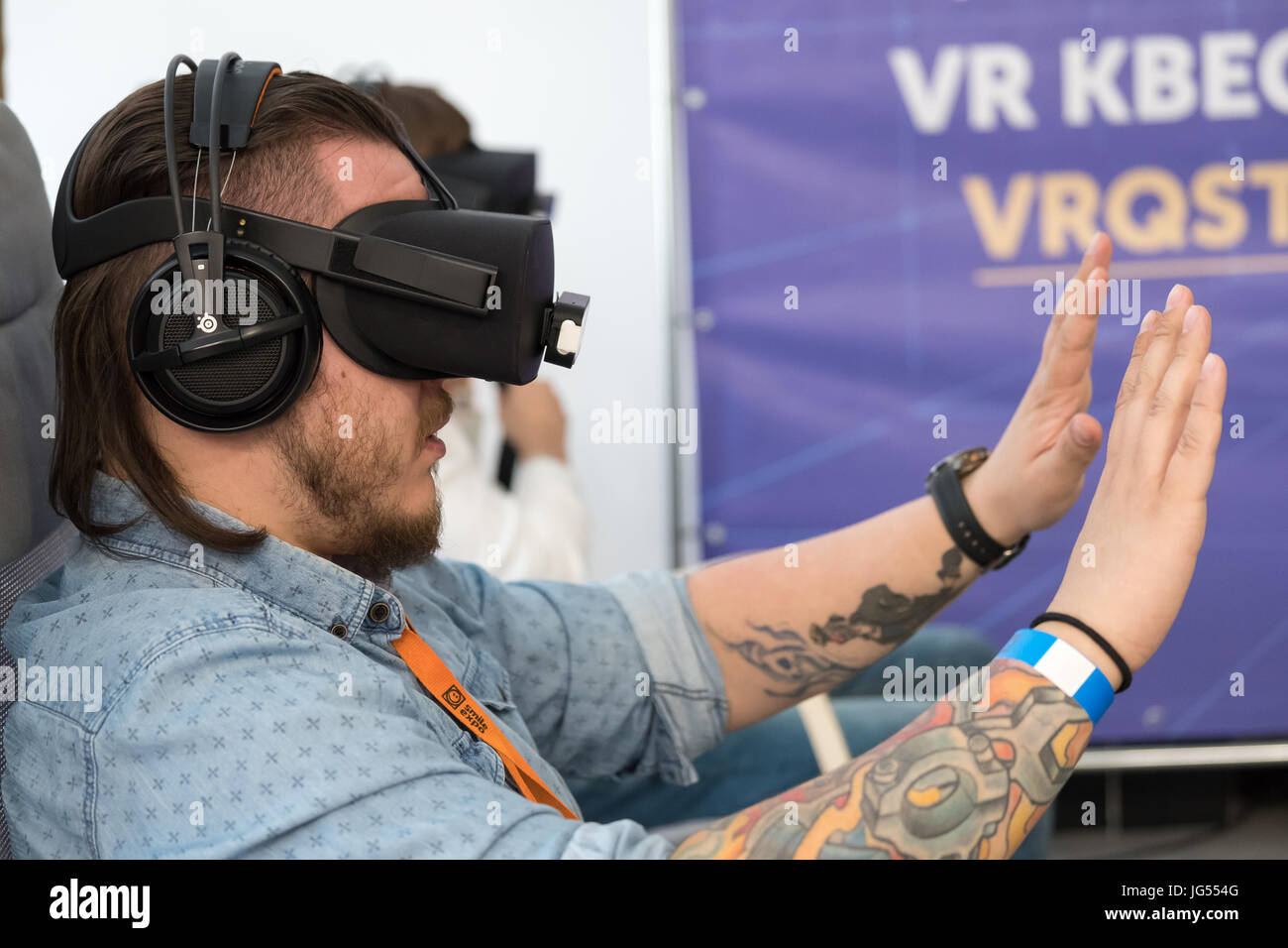 VR conference visitor tests virtual reality helmet Stock Photo - Alamy