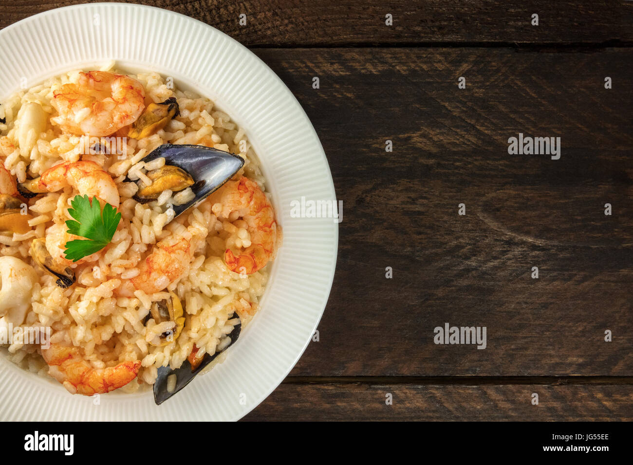 Seafood risotto on dark rustic background with copyspace Stock Photo ...