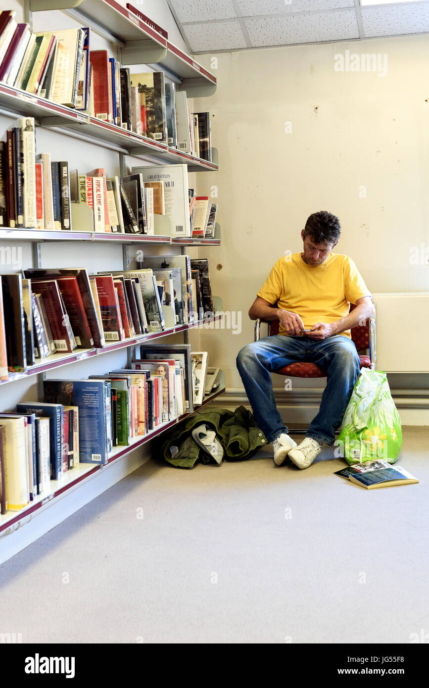 Man reading paper in chair hi-res stock photography and images - Alamy