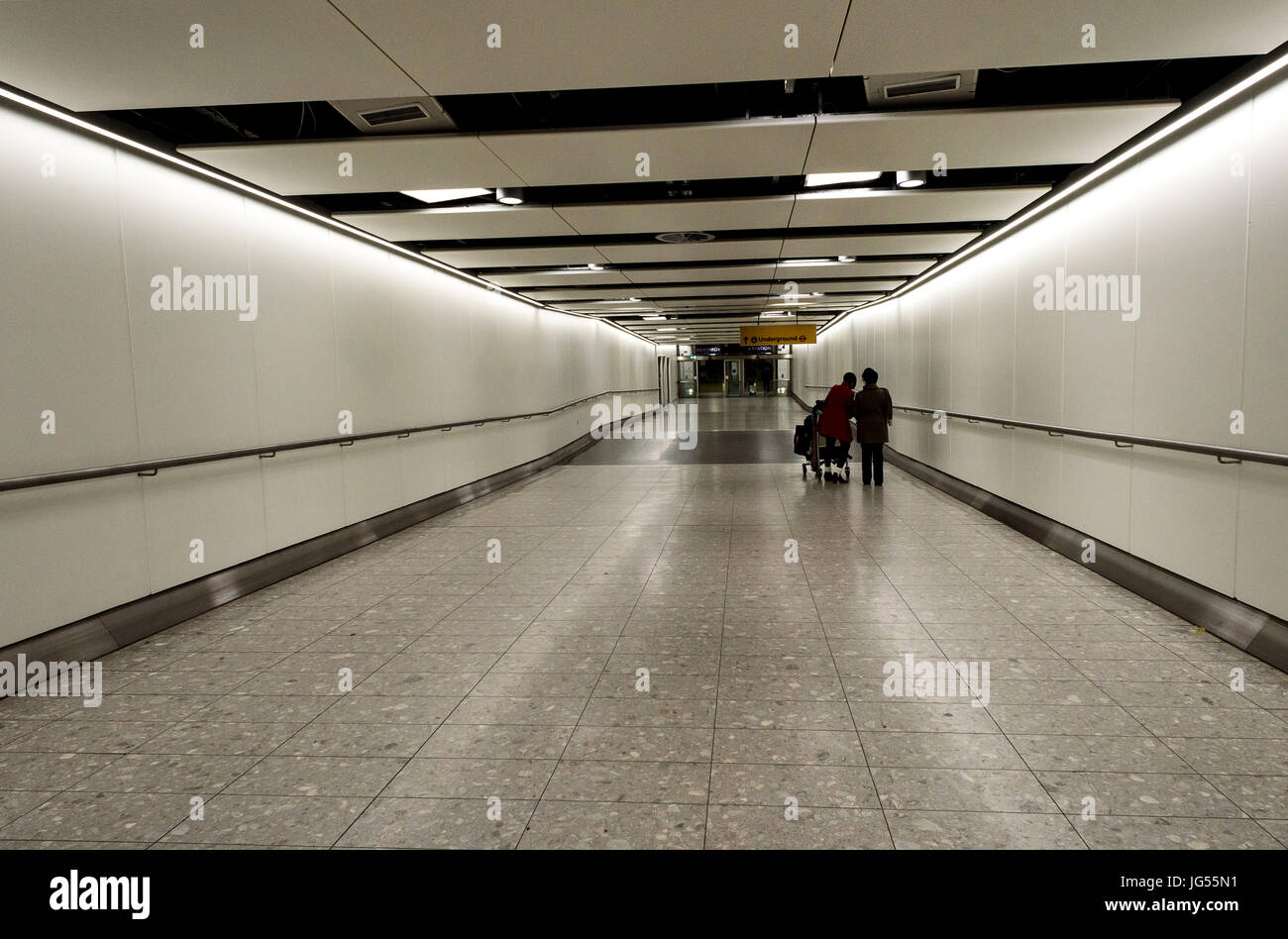 Two woman lost in london underground terminal inside a long tunell ...