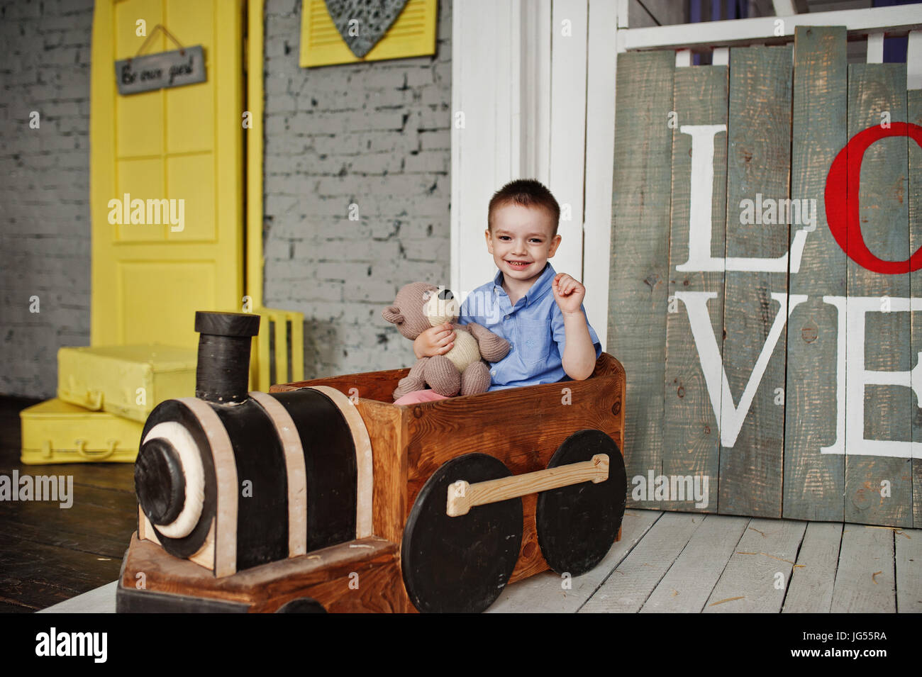 Little handsome boy stylishly dressed posing on the toy train Stock ...