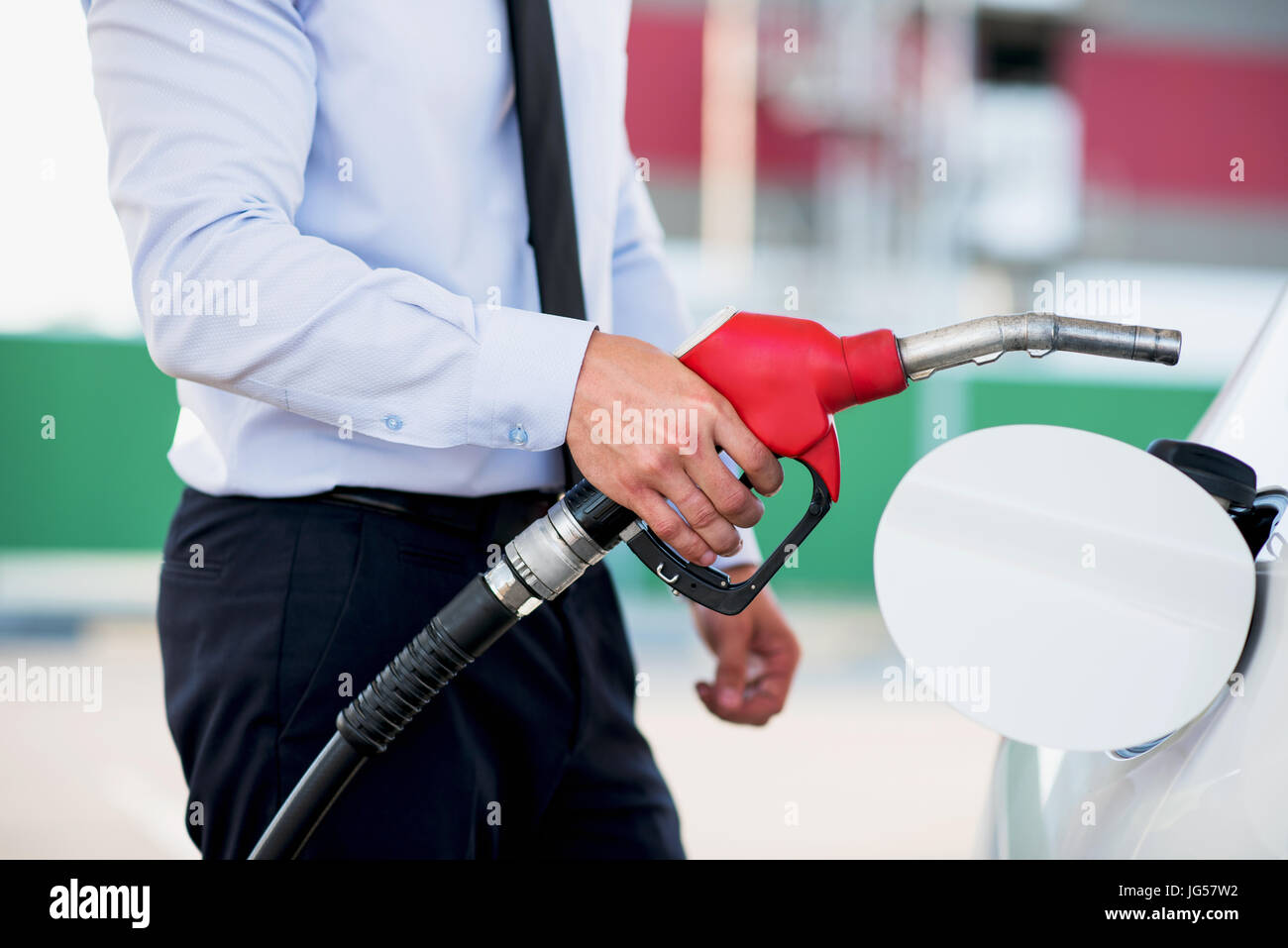 process of refueling the white car with petrol Stock Photo - Alamy