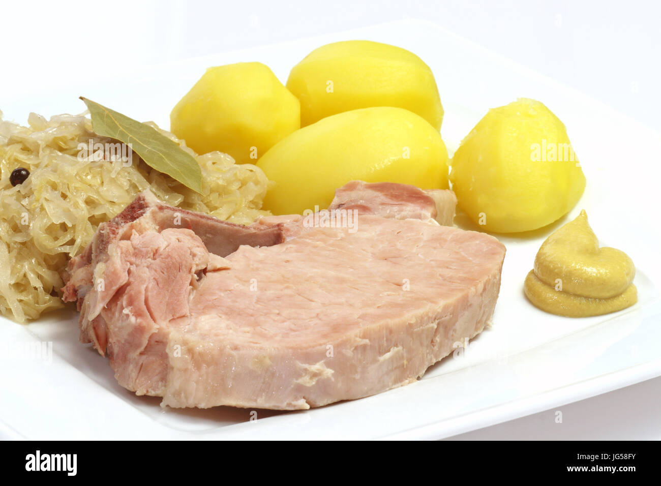 Traditional german pork meat with sauerkraut and potatoes Stock Photo ...