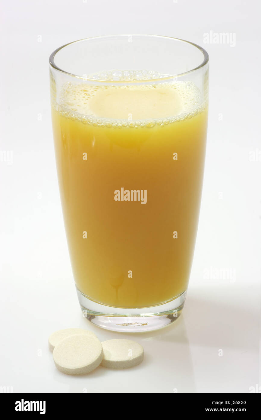 Glas of fizzy liquid with Effervescent tablets on bright background ...