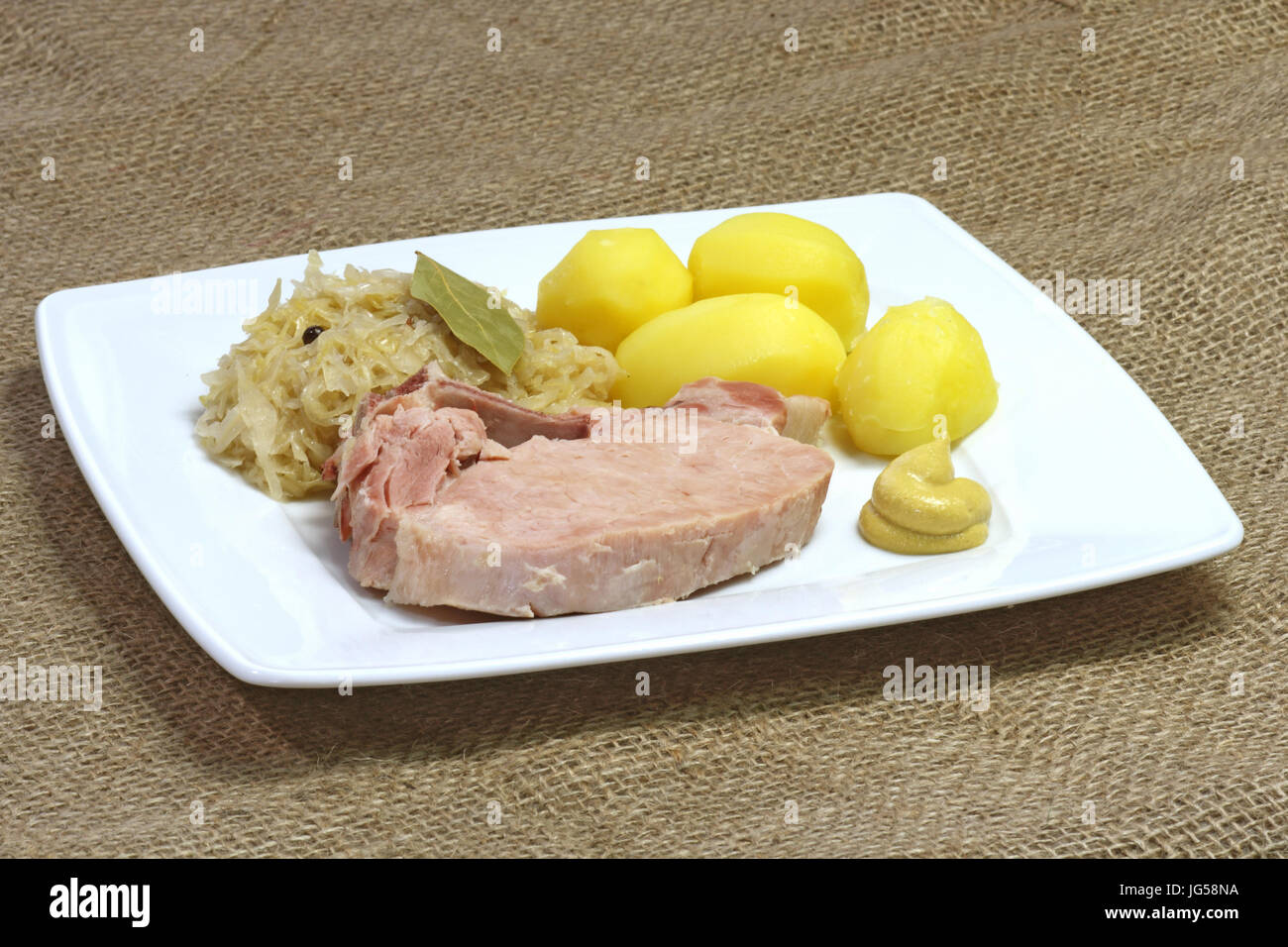 Traditional german pork meat with sauerkraut and potatoes Stock Photo ...