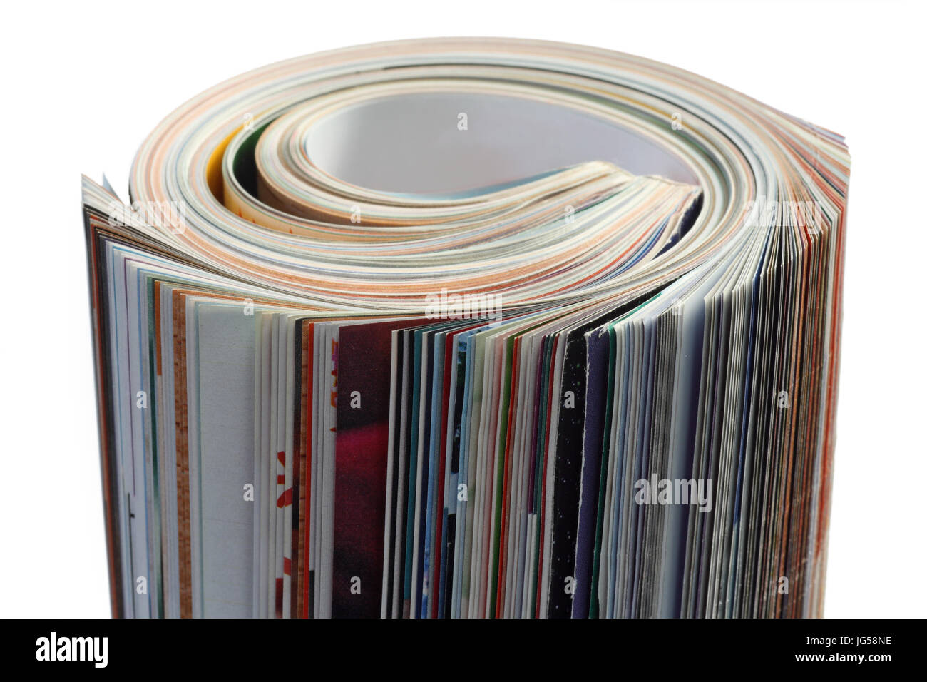 Rolled up magazine on bright background Stock Photo - Alamy