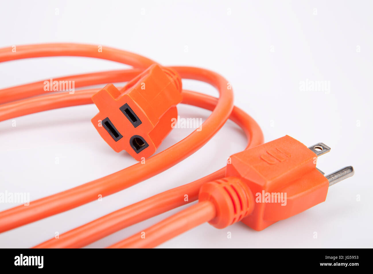 Bright orange extension cord on a white surface. Orange extension cable ...