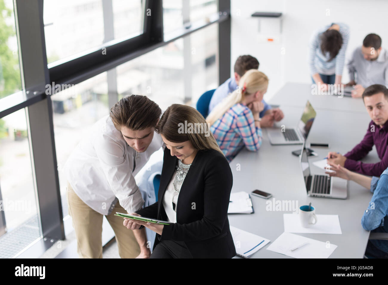 two business people using tablet preparing for next meeting and ...