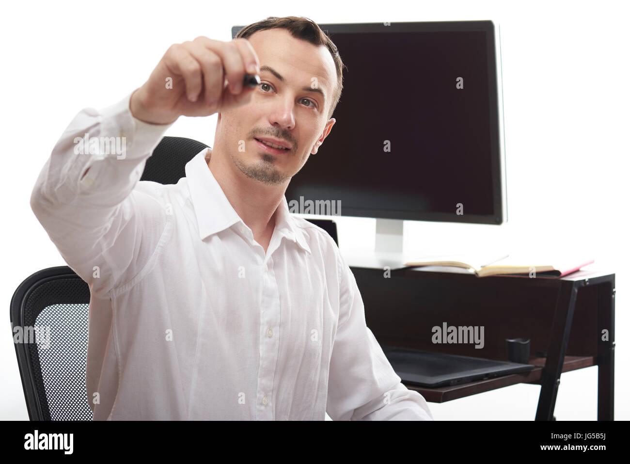 Young man drawing graphic in white office background. Business man ...
