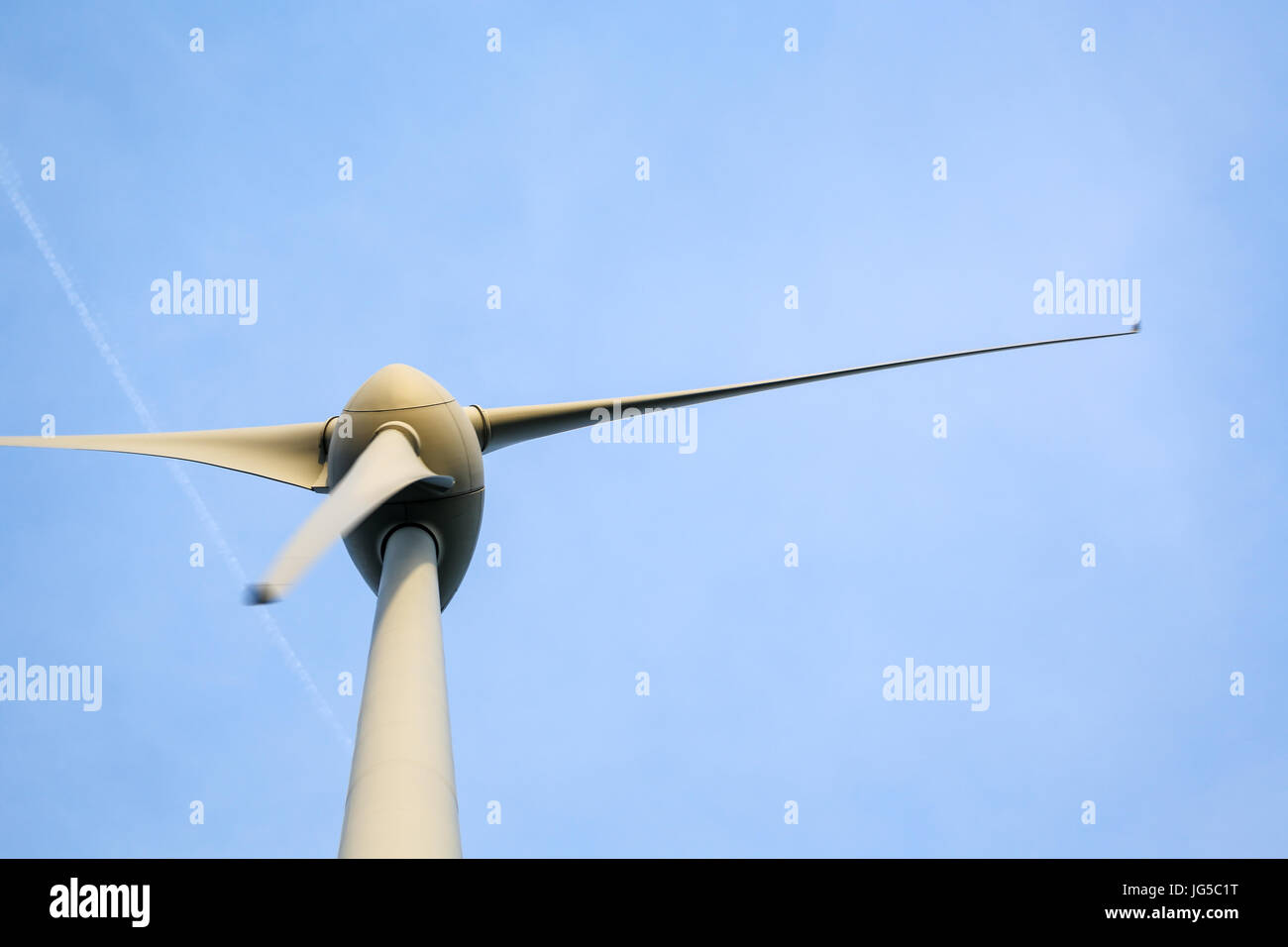 Single, modern windmill against blue sky during sunset Stock Photo - Alamy