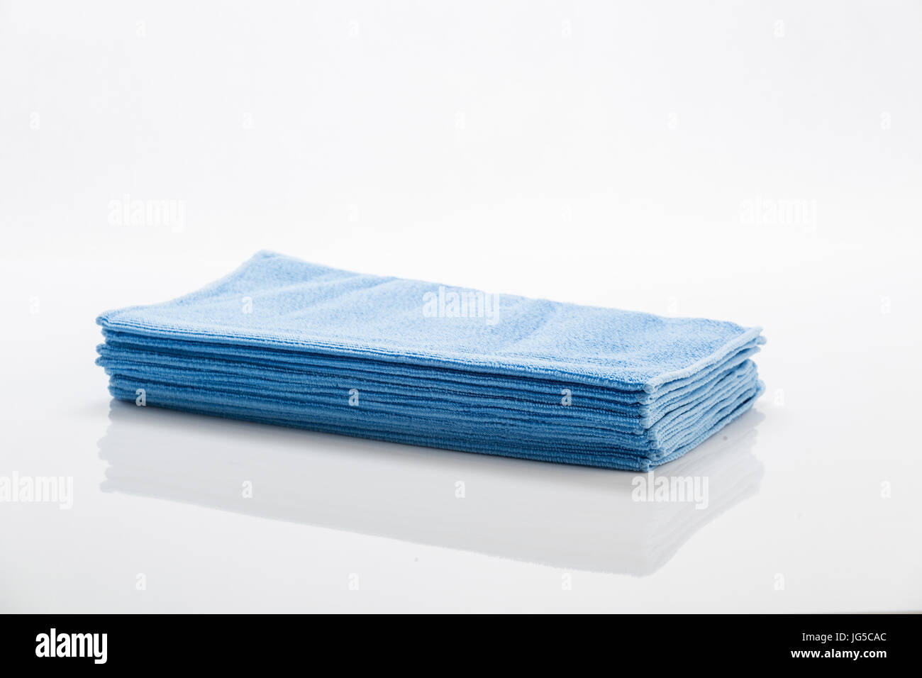 Blue cleaning clothes isolated on white background Stock Photo - Alamy