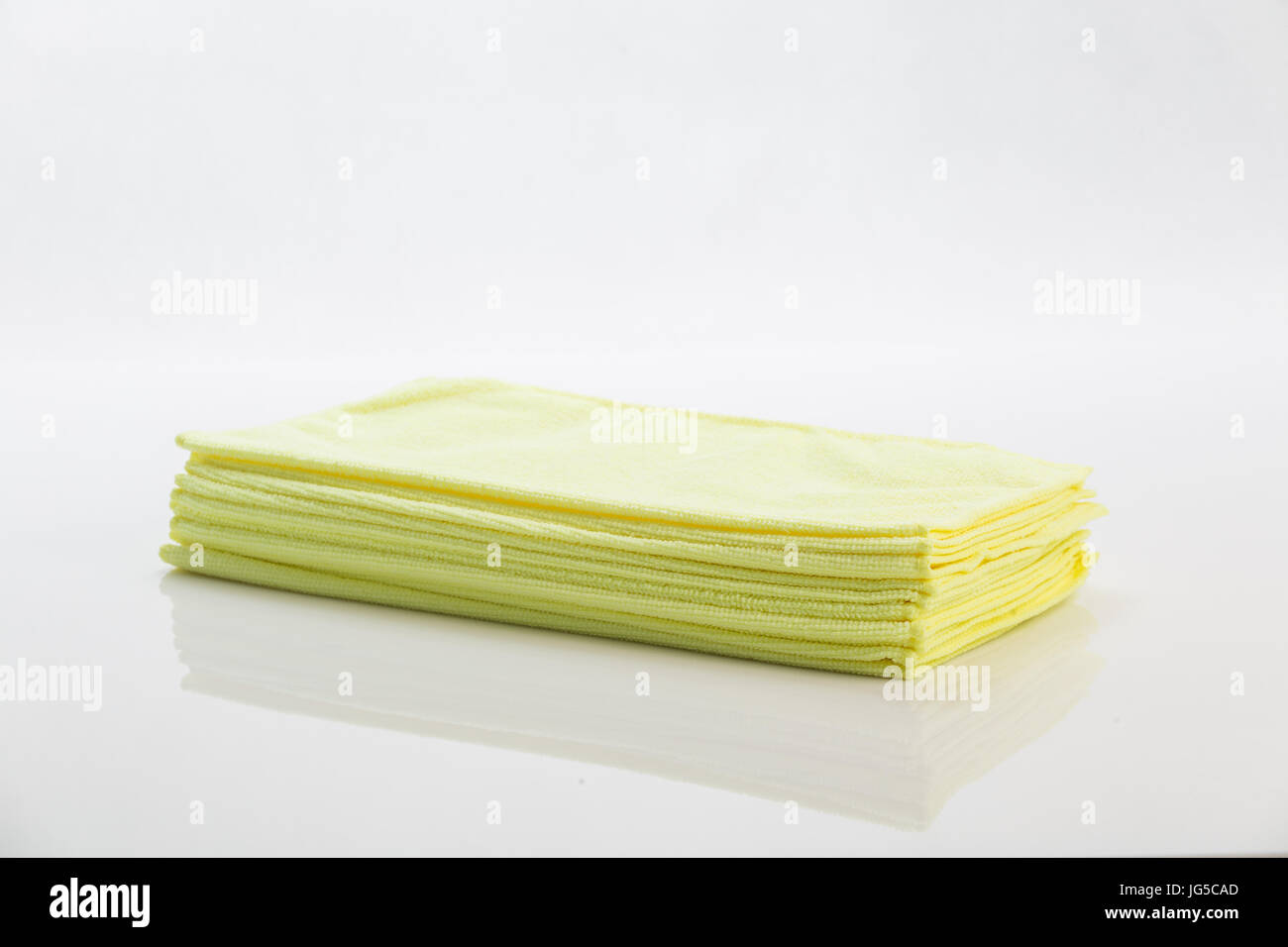 Yellow cleaning clothes isolated on white background Stock Photo - Alamy