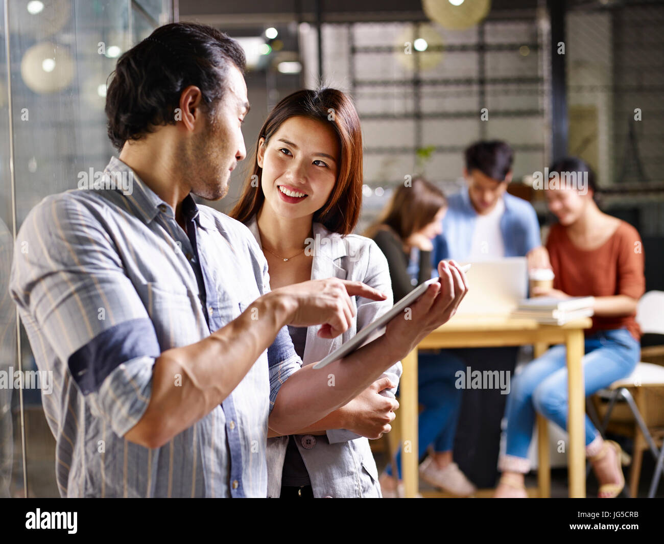 people in small start-up company discussing business in office Stock ...