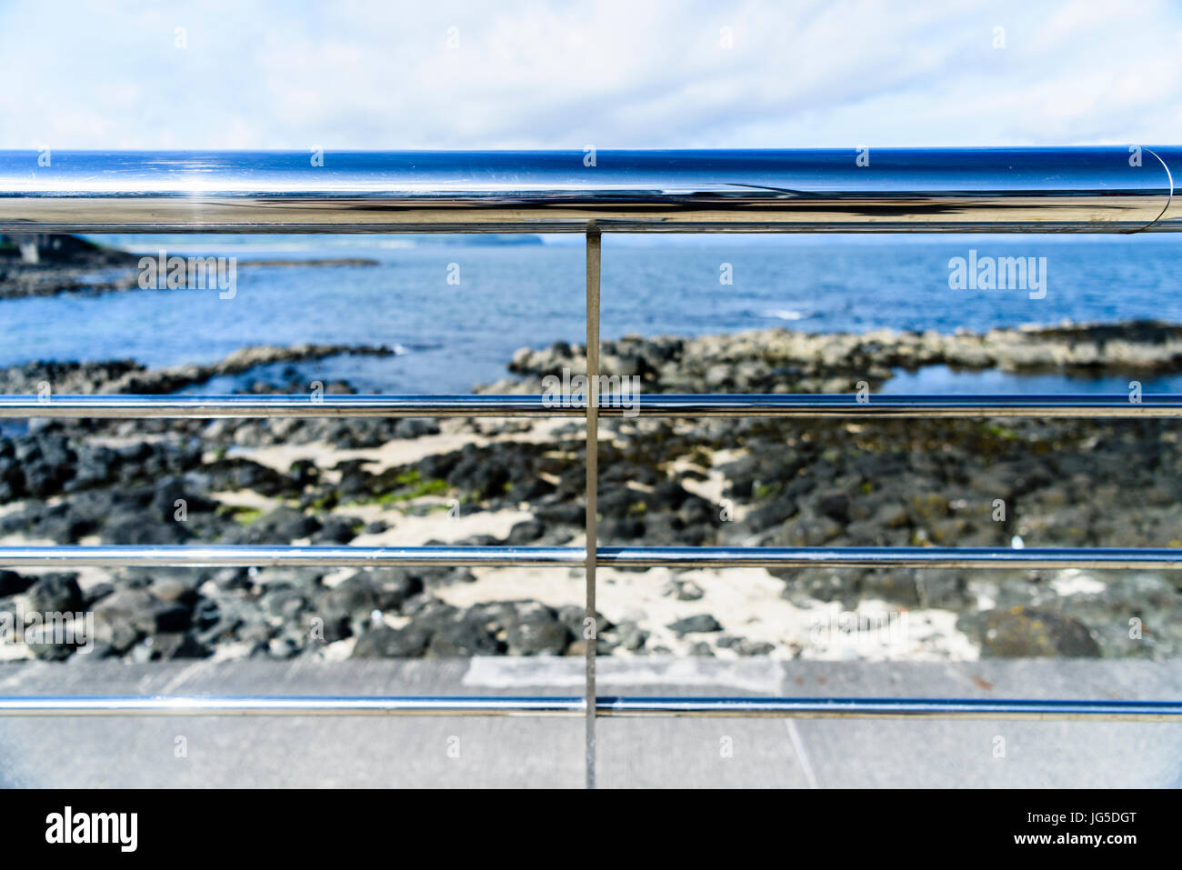 Stainless steel railings along a seafront Stock Photo - Alamy