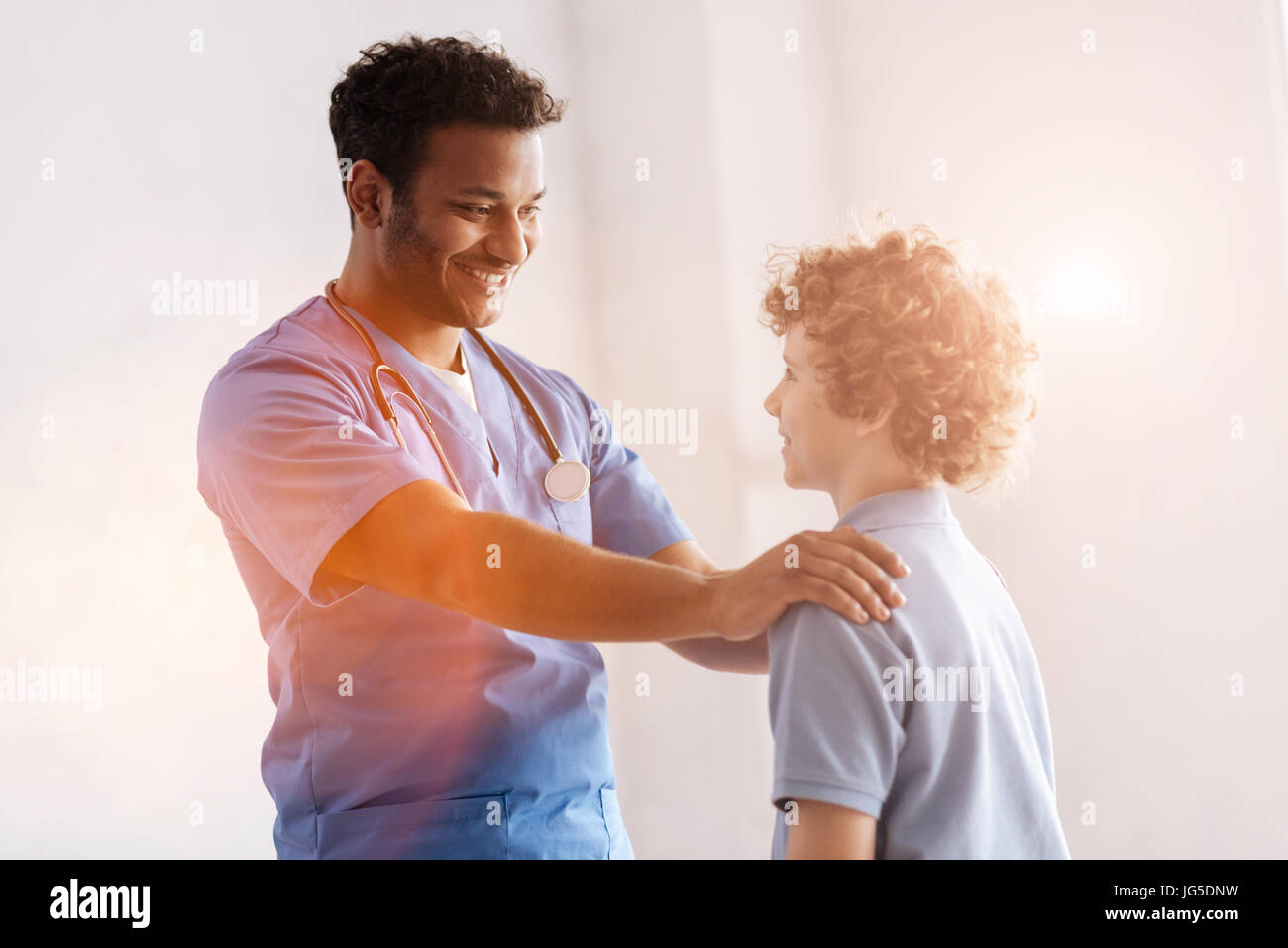 Kind professional calming his visitor Stock Photo - Alamy