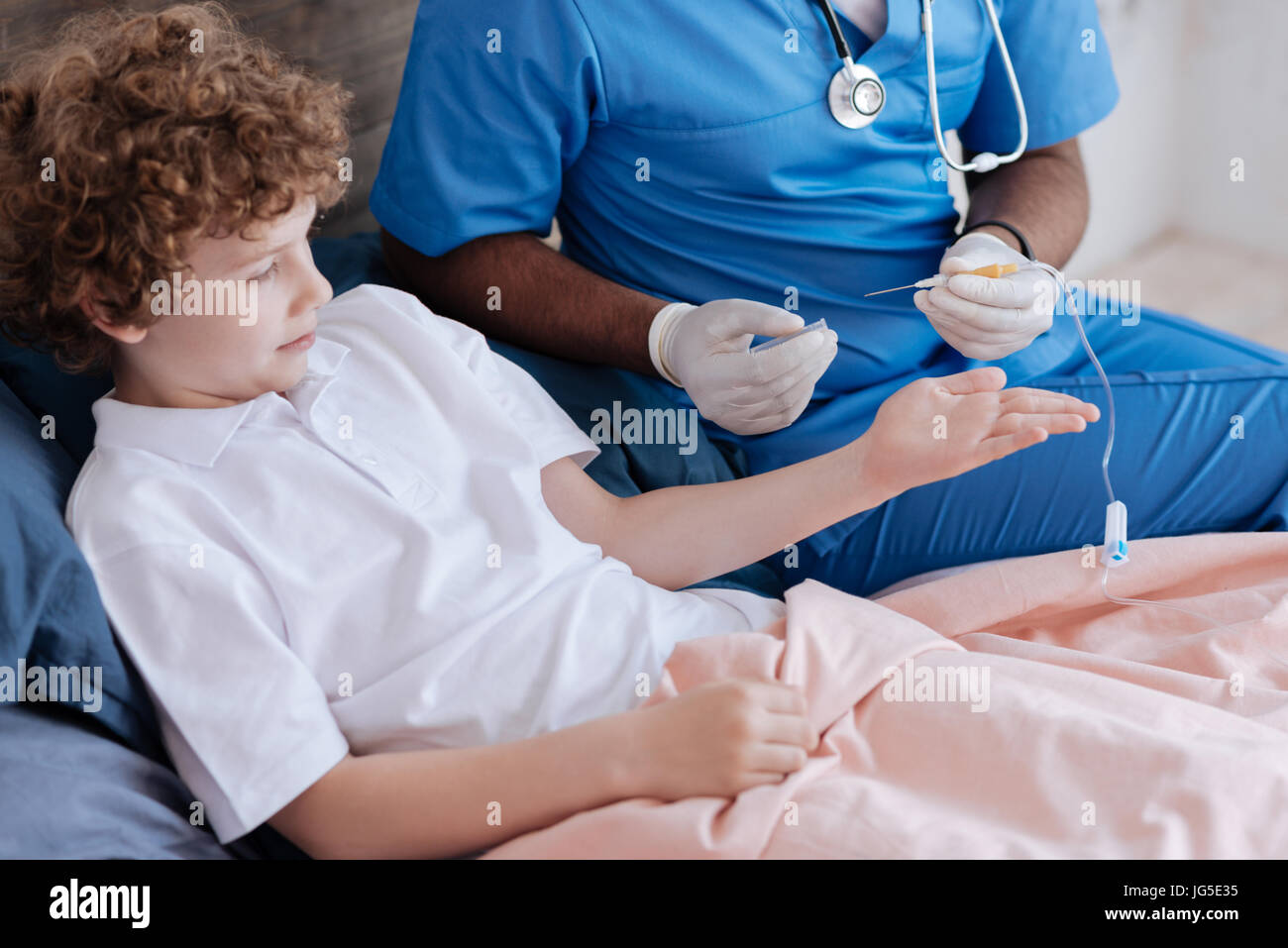 Nervous boy giving his hand for prick Stock Photo - Alamy