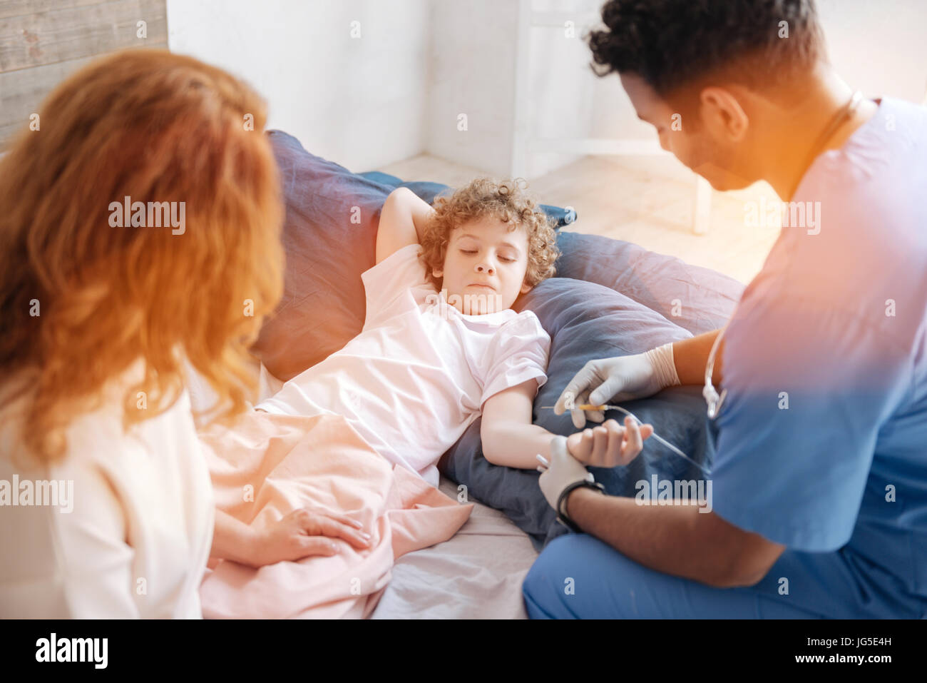 Serious boy giving his hand for prick while suffering pain Stock Photo ...