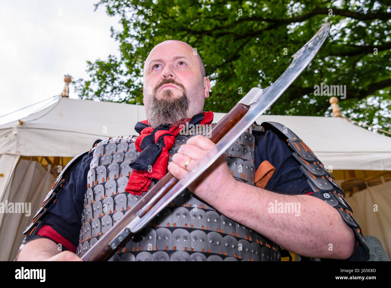 A large man holds a large, dangerous medieval sharp bladed axe Stock ...
