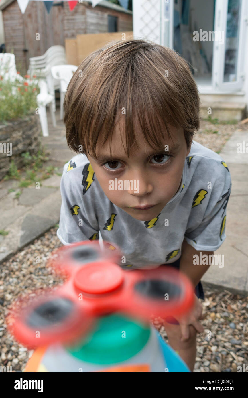 Boy with fidget spinner hi-res stock photography and images - Alamy