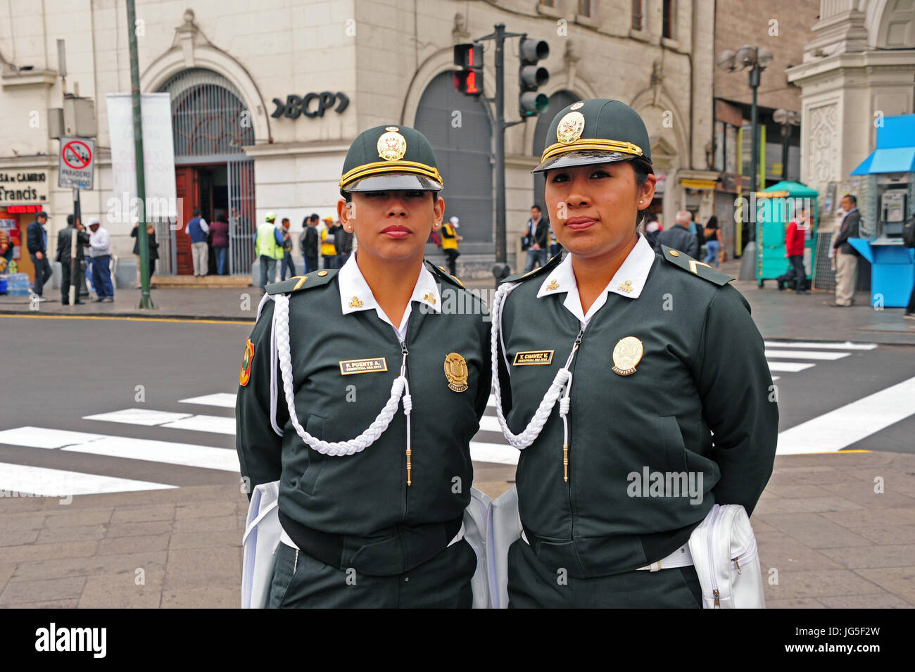 Two police officers stand on Plaza Bolivar in the Old Town of Lima ...