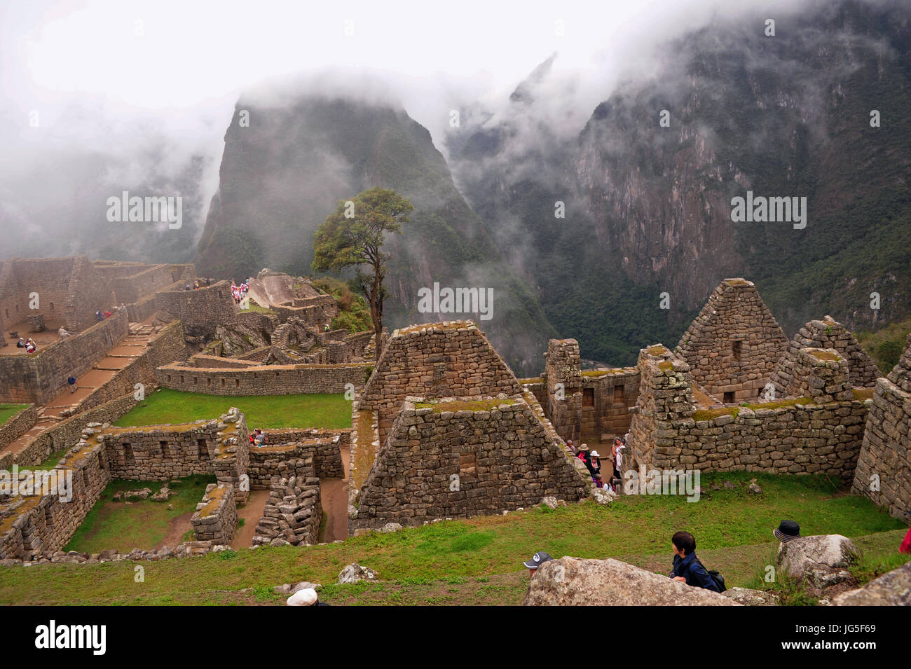 Tourists often experience the famous Inca ruins site of Machu Picchu in ...