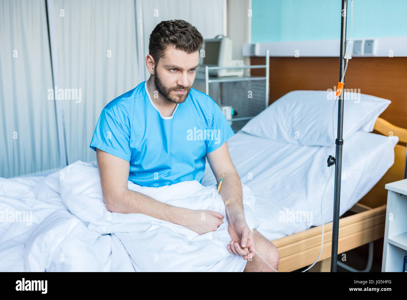 Man sitting on hospital bed hi-res stock photography and images - Alamy