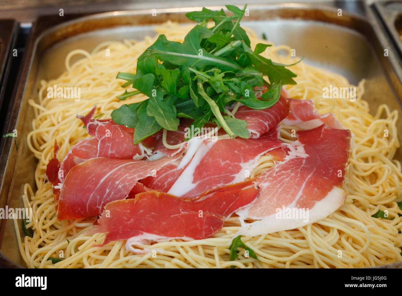 Raw Spaghetti Carbonara Pasta noodles with raw ham and salad Stock ...