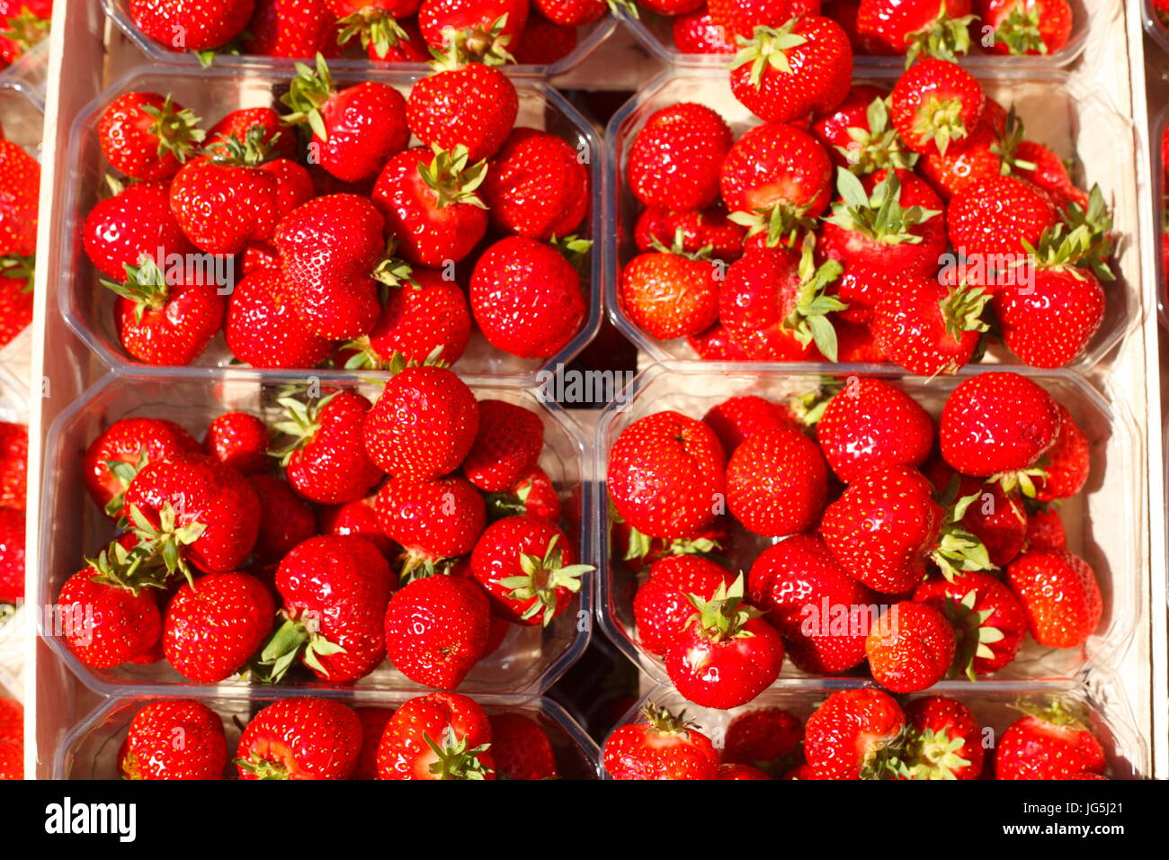 Fresh Strawberries in plastic boxes on a Market Stall Stock Photo - Alamy