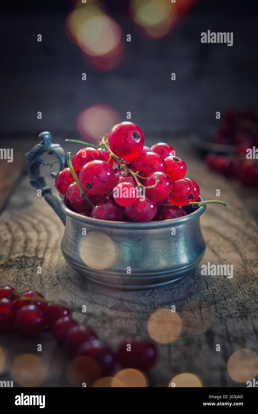 Cup of Red currants on rustic wood aces table Stock Photo - Alamy