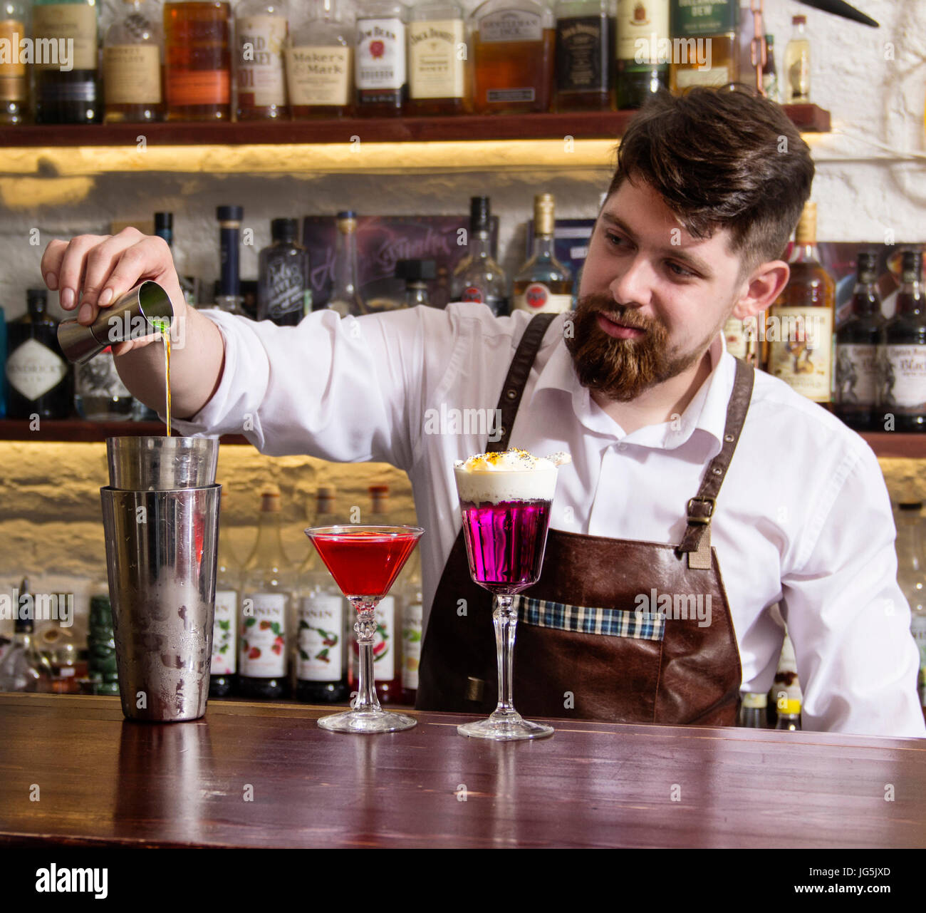 Smiling Bartender making alcohol coctail in restaurant Stock Photo - Alamy