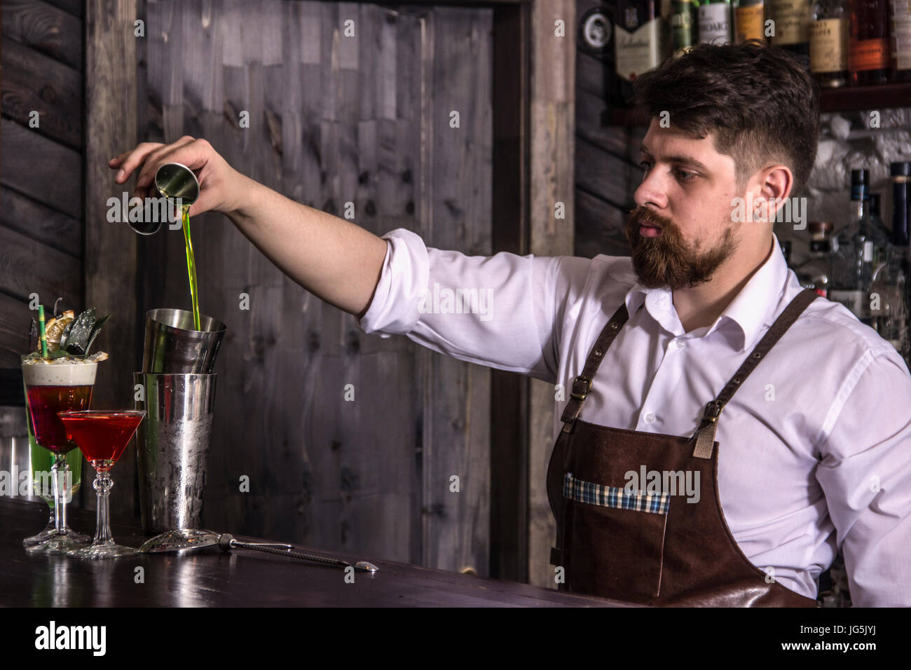 brutal bartender making alcohol coctail in restaurant Stock Photo - Alamy